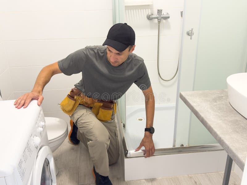 Plumber Fixing Washing Machine on White Background Stock Image - Image ...