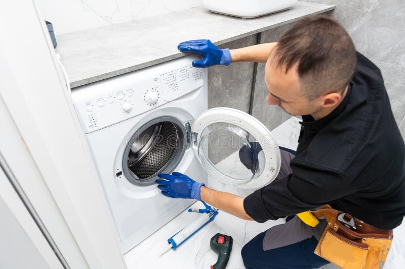 Plumber Fixing Washing Machine on White Background Stock Image - Image ...