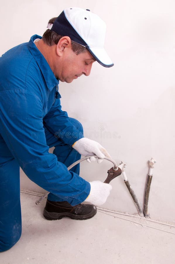 Plumber fixing water pipe stock image. Image of repairman - 19467813