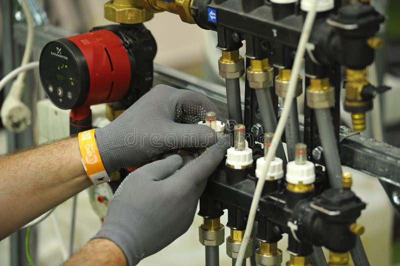 Plumber Hands Assembling Heating Manifold of a House Heating System ...