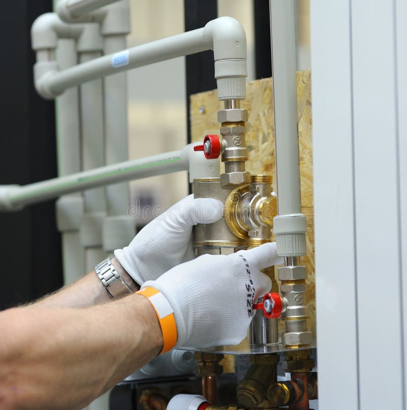 Plumber Hands in Gloves Joining Pipes of a House Heating System Stock ... Plumber Hands in Gloves Joining Pipes of a House Heating System Stock ...
