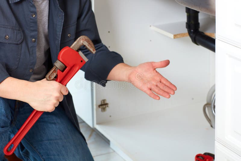 Plumber hands with wrench. stock image. Image of hand - 90330187