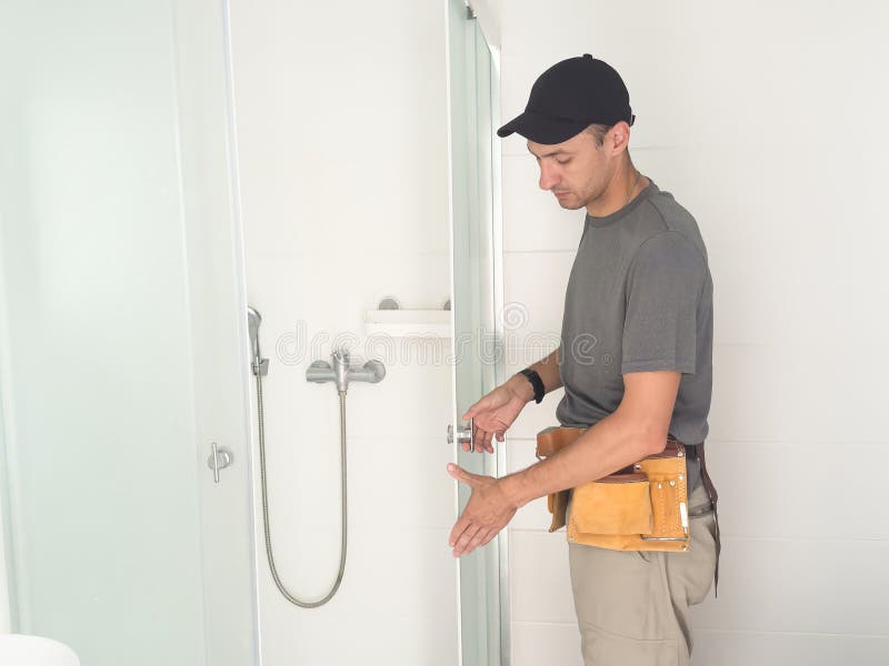 Plumber Installing a Shower Cabin in Bathroom Stock Photo - Image of ...