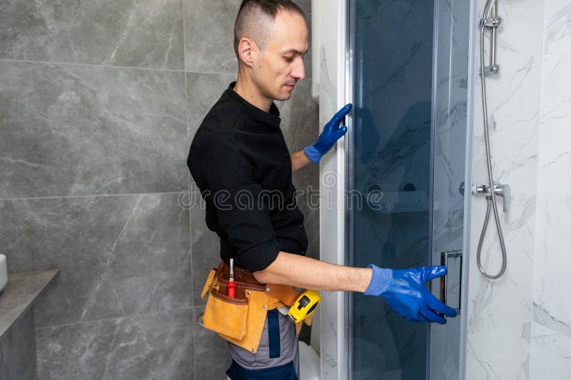 Plumber Installing a Shower Cabin in Bathroom Stock Photo - Image of ...