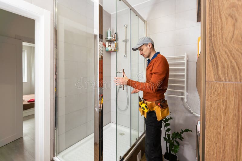 Plumber Installing a Shower Cabin in Bathroom Stock Photo - Image of ...
