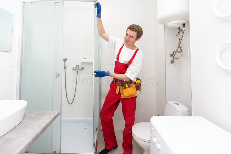 Plumber Installing a Shower Cabin in Bathroom Stock Image - Image of ...
