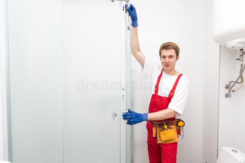 Plumber Installing a Shower Cabin in Bathroom Stock Photo - Image of ...