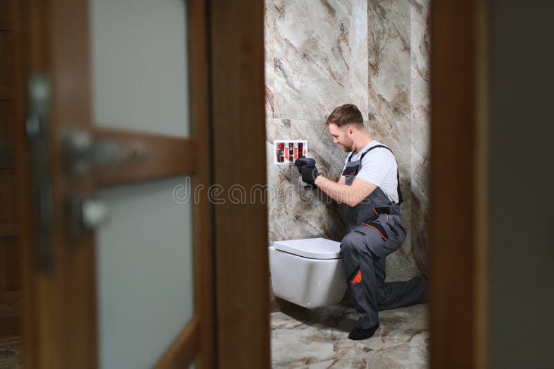 Plumber Installing Toilet in Restroom Stock Image - Image of ...
