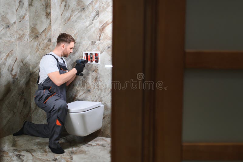 Plumber Installing Toilet in Restroom Stock Photo - Image of caucasian ...