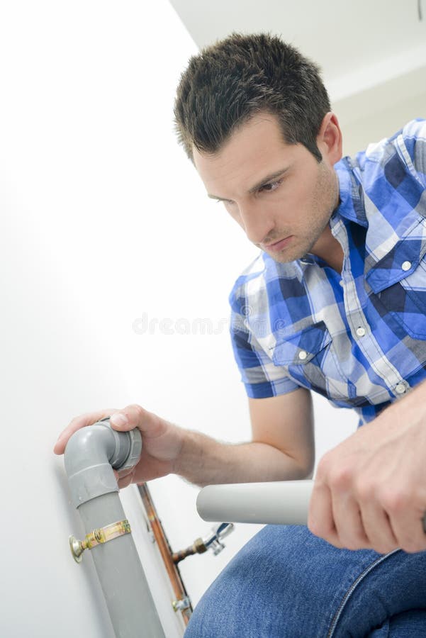 Plumber Joining Plastic Pipes with Glue Cement for Drains Under ...