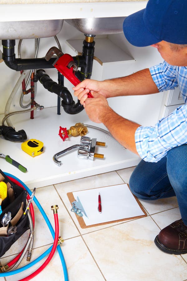 Plumber on the kitchen. stock image. Image of service - 47973687