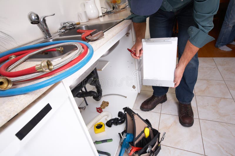 Plumber on the kitchen. stock image. Image of handyman - 64479909