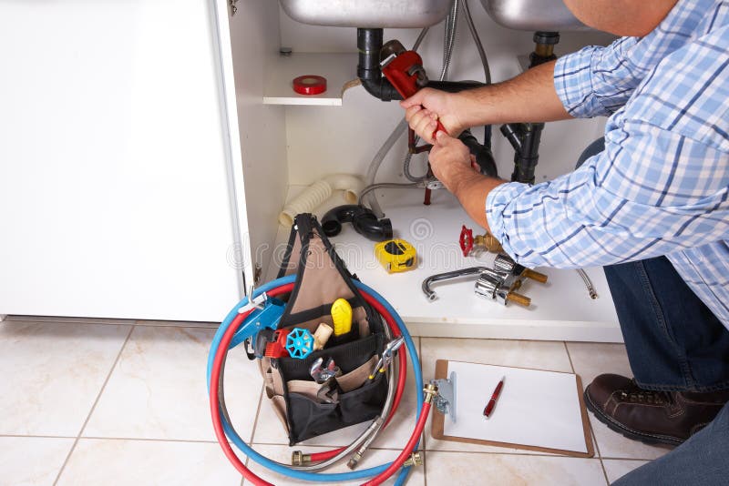Plumber on the kitchen. stock image. Image of service - 47973687