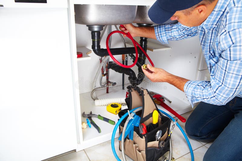 Plumber on the kitchen. stock image. Image of service - 47973687