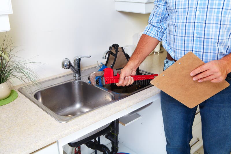 Plumber on the kitchen. stock image. Image of hand, clogged - 48046217