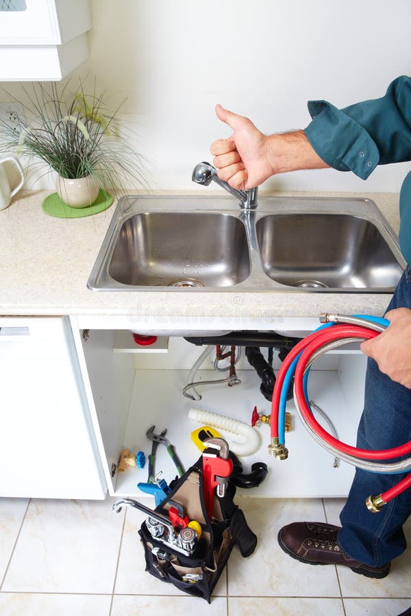 Plumber on the kitchen. stock image. Image of handyman - 48083327