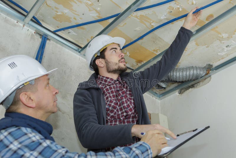 Plumber on Ladder Pointing at Problem Stock Image - Image of builder ...