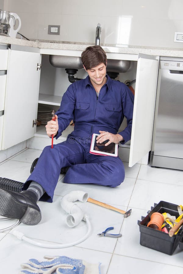 Plumber Looking at the Instructions in Your Tablet Stock Image - Image ...