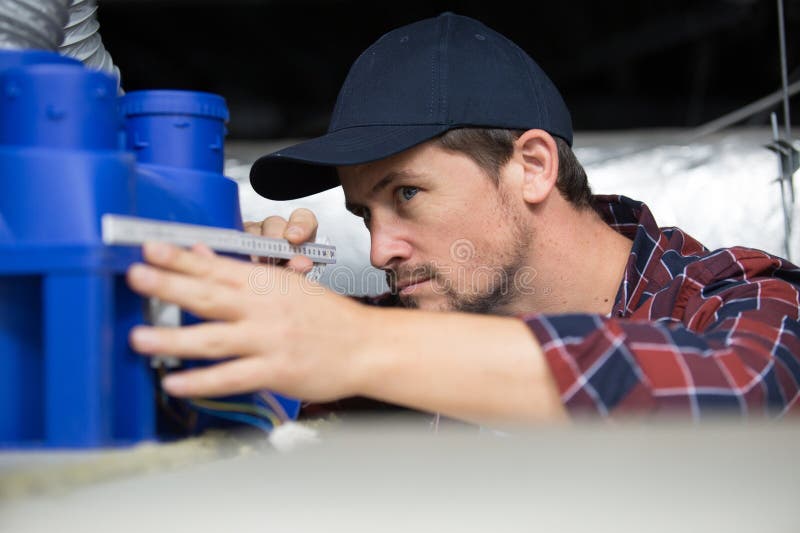 Plumber measuring pipe stock image. Image of operator - 273523335