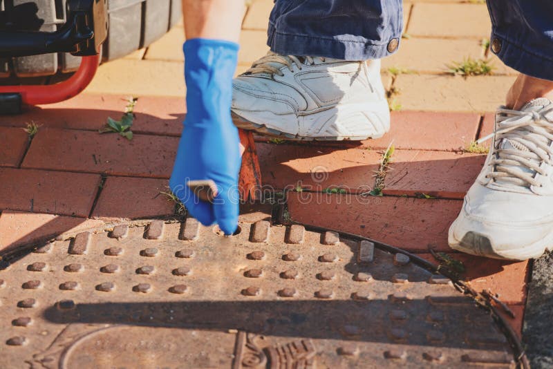 The Plumber Opens a Sewer Hatch. Close-up Stock Photo - Image of ...