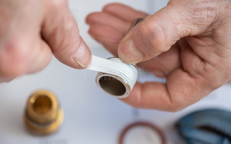 Plumber using seal tape stock photo. Image of technician - 178154754