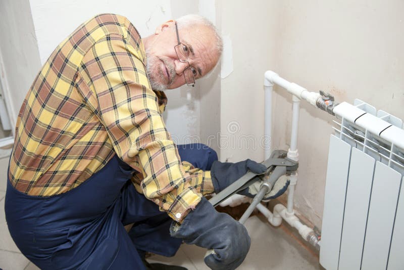 Plumber repairing pipes stock image. Image of workforce - 33836037