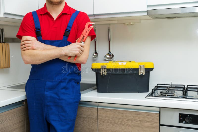 Plumber Standing in Domestic Kitchen Stock Photo - Image of uniform ...