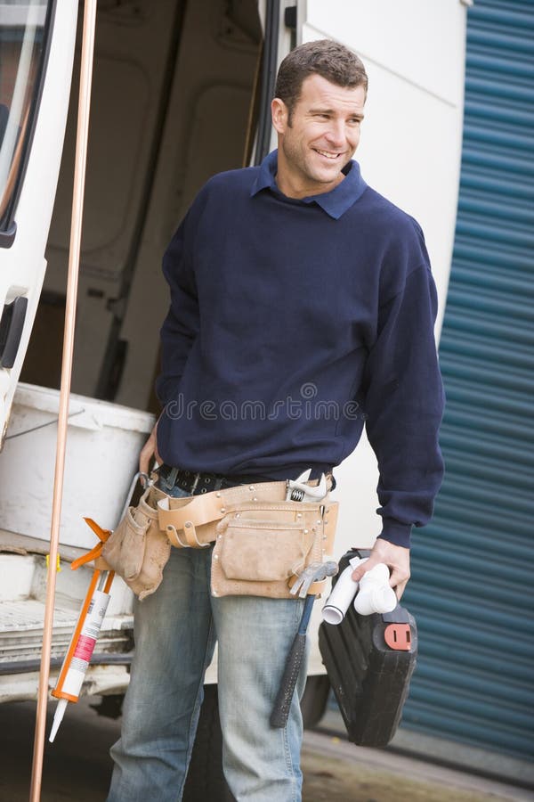 Plumber standing with van stock photo. Image of toolbelt - 5940822