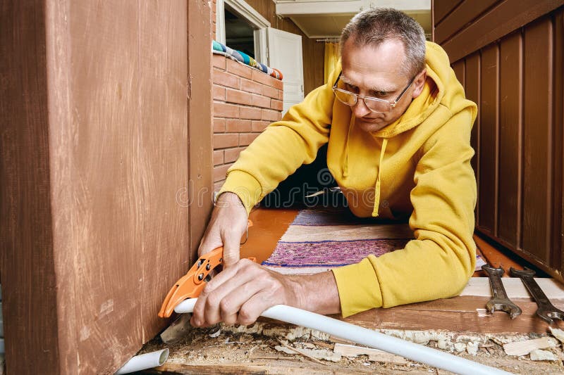Plumber Trims Plastic Pipe Using Cutting Tool To Ensure Proper ...