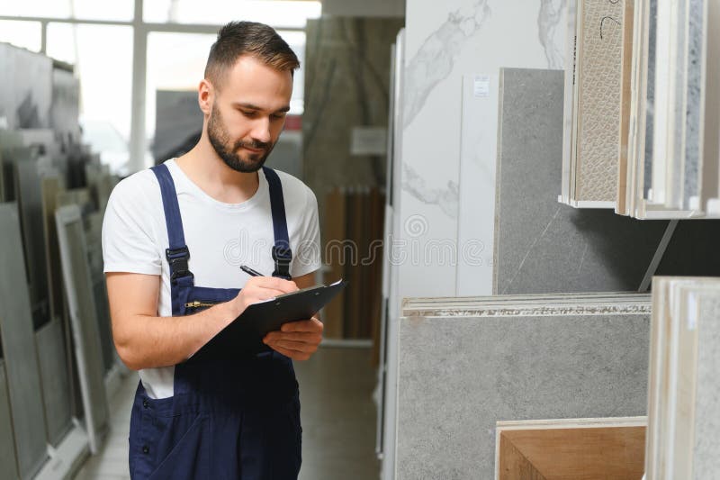 Plumber in Uniform at Showcase in Plumbering Store Stock Photo - Image ...