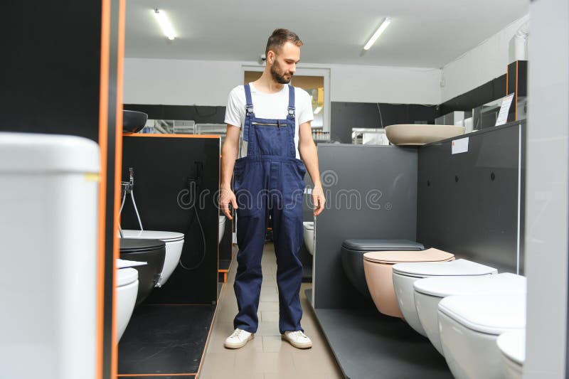 Plumber in Uniform at Showcase in Plumbering Store Stock Image - Image ...