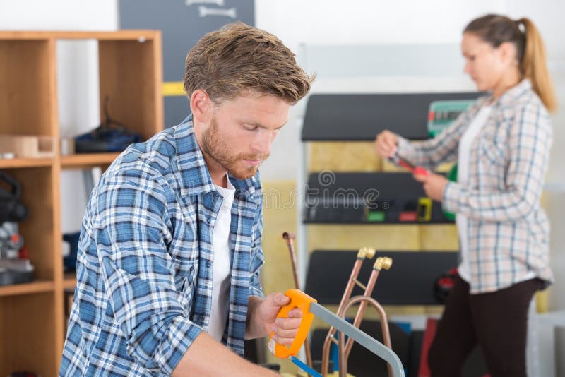Plumber Using Hacksaw To Cut Down Pipes Stock Photo - Image of iron ...