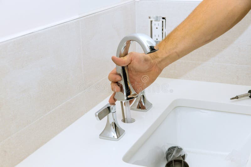 Plumber Assemble and Install Water Faucet in the Bathroom Stock Image ...