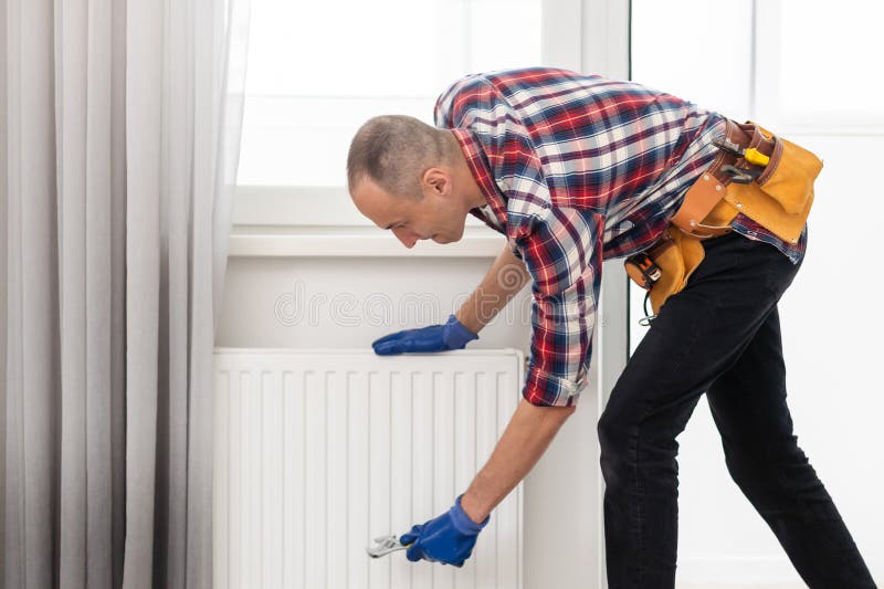 Plumber at Work. Installing Water Heating Radiator Stock Photo - Image ...