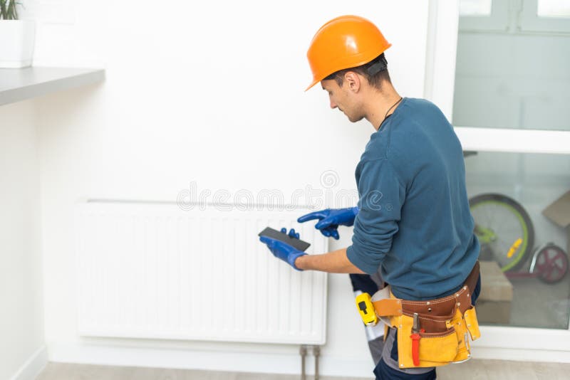 Plumber at Work. Installing Water Heating Radiator Stock Photo - Image ...