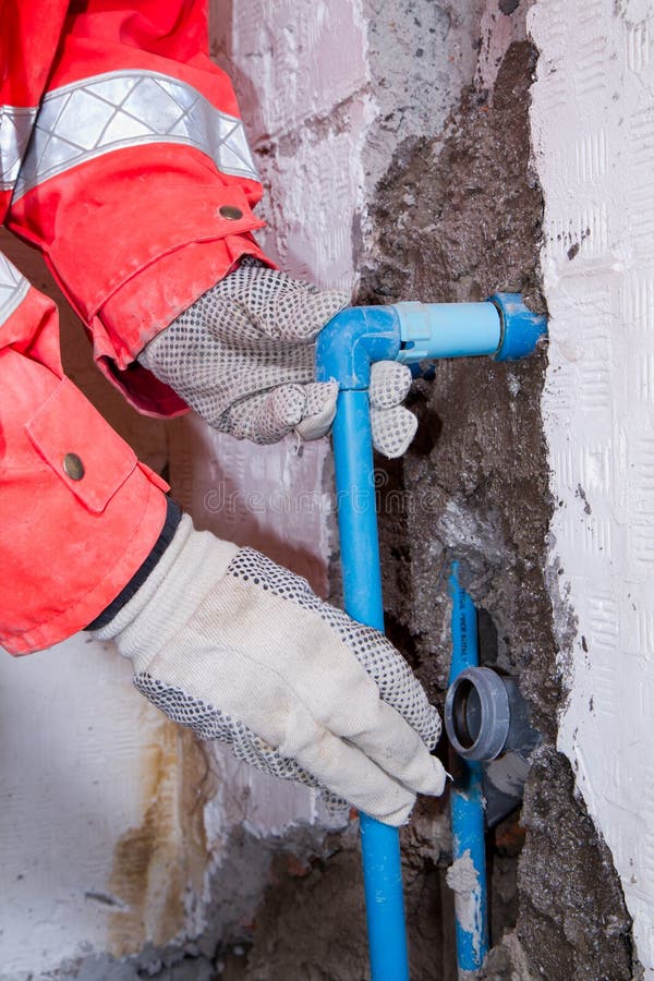 Plumber at work in a site stock photo. Image of mason - 67901040
