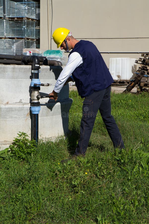Plumber at work in a site stock image. Image of laborer - 67901831