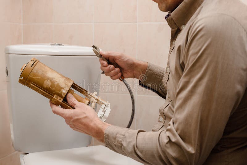Plumber at work in wc stock photo. Image of hands, device - 259339518
