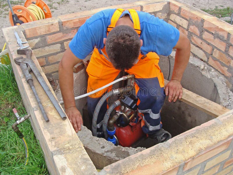 Plumber in well 3 stock photo. Image of water, open - 167963390