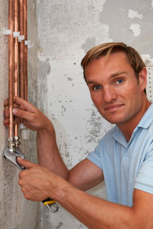 Plumber Working on Pipes at Construction Site Stock Image - Image of ...