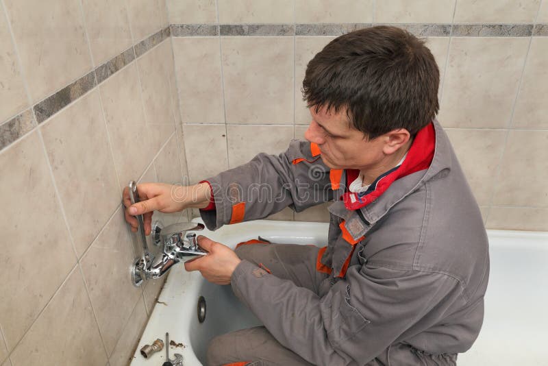 Plumber Works in a Bathroom Stock Photo - Image of bathroom, closeup ...