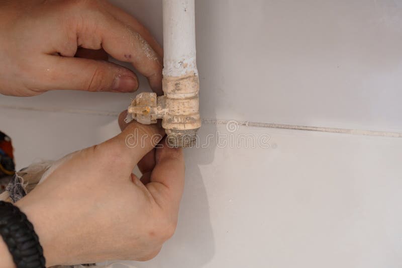 Plumbing Repair: Fixing a Leaking Pipe Fitting in a Kitchen Stock Image ...