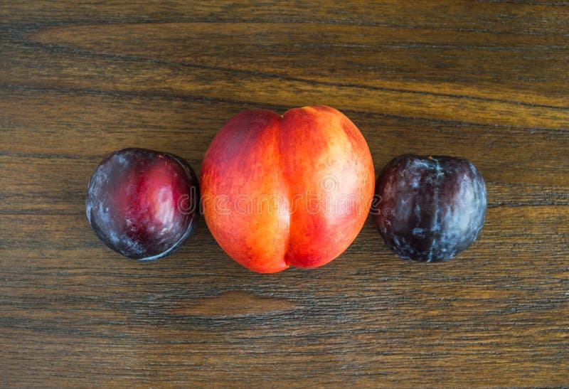Plums and a Nectarine on a Wooden Table Viewed from Above Stock Image ...