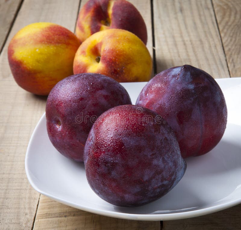 Plums and Peaches Over Rustic Wooden Table Stock Photo - Image of ...