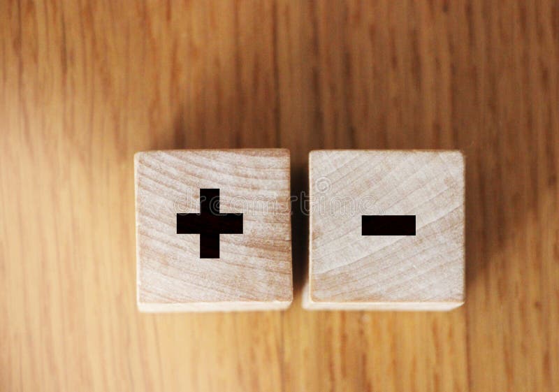 Plus and Minus Signs on Wooden Cubes on Wooden Table. Business Solution ...