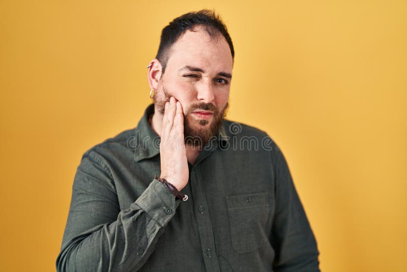 Plus Size Hispanic Man with Beard Standing Over Yellow Background ...