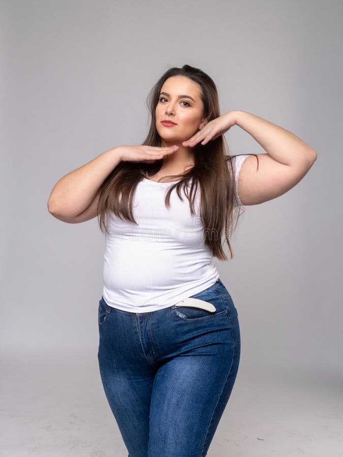 Plus Size Model with Long Hair Posing in Studio Stock Photo - Image of ...