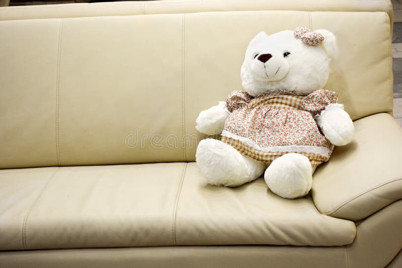 Plush bear on the couch stock photo. Image of interior - 94513234