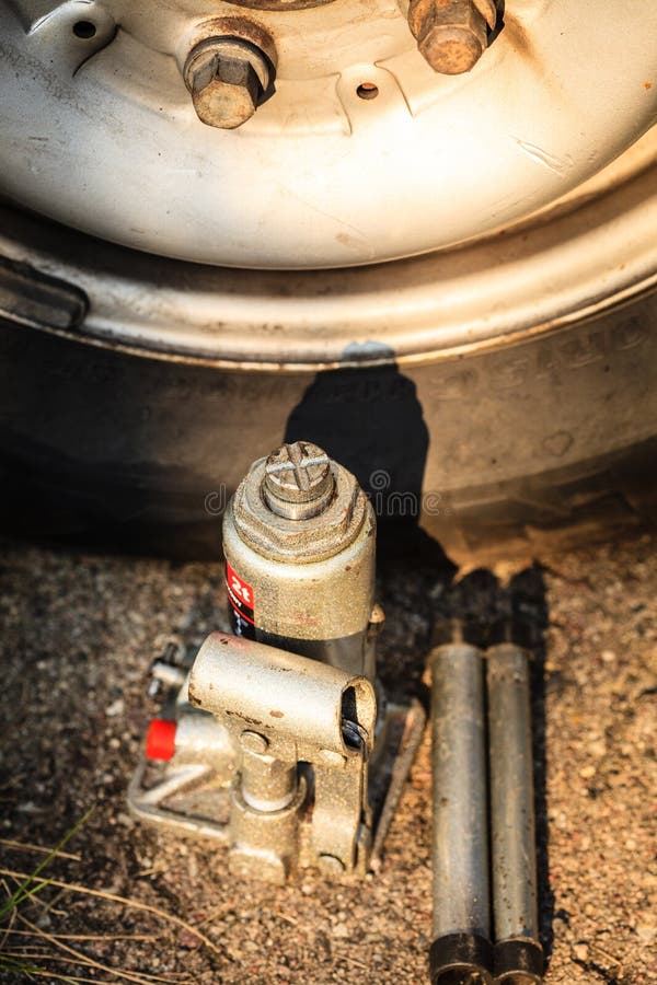 Pneumatic Car Jack Next To Old Tire Stock Photo - Image of fixing ...
