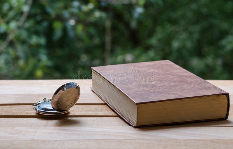 Pocket watch and the book stock photo. Image of table - 96738914